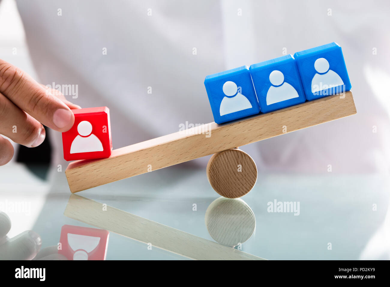 Person showing unbalance between single red block and blue blocks with ...