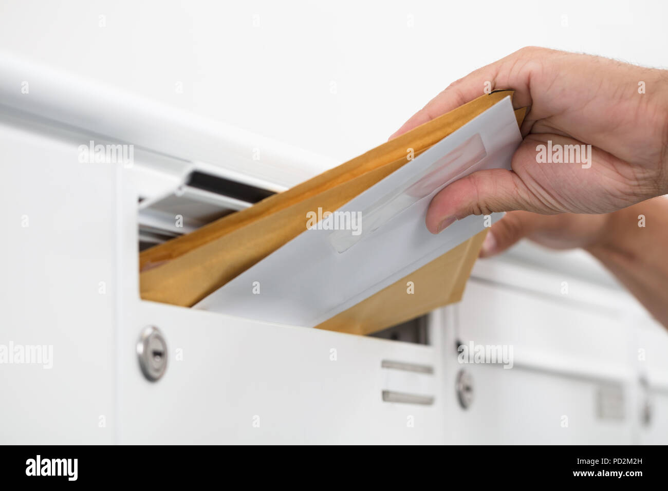 Close-up of a man's hand inserting letters in mailbox Stock Photo - Alamy