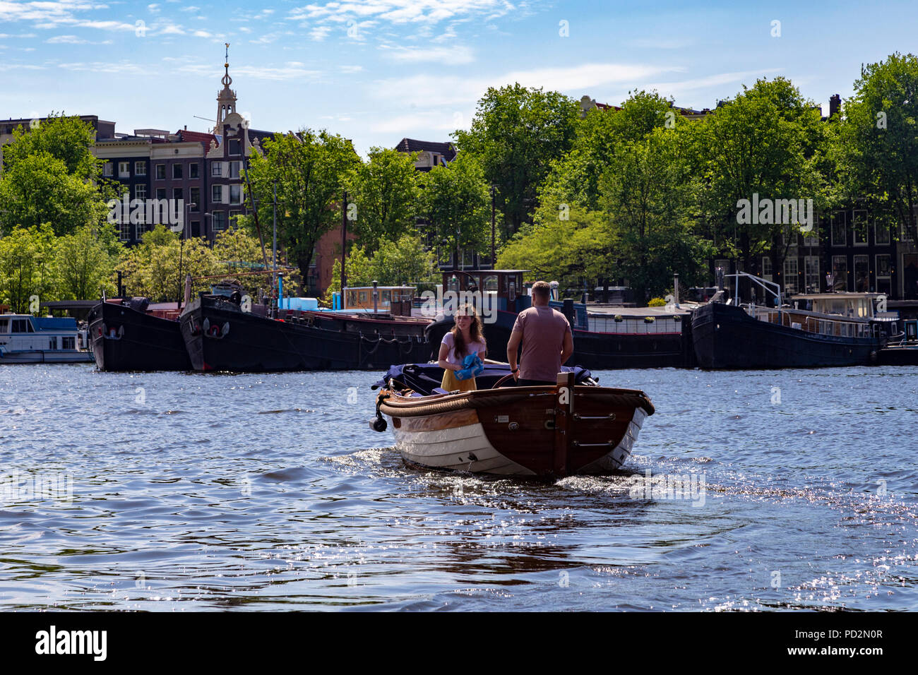 Couple riding a boat in Amsterdam, Netherlands Stock Photo - Alamy