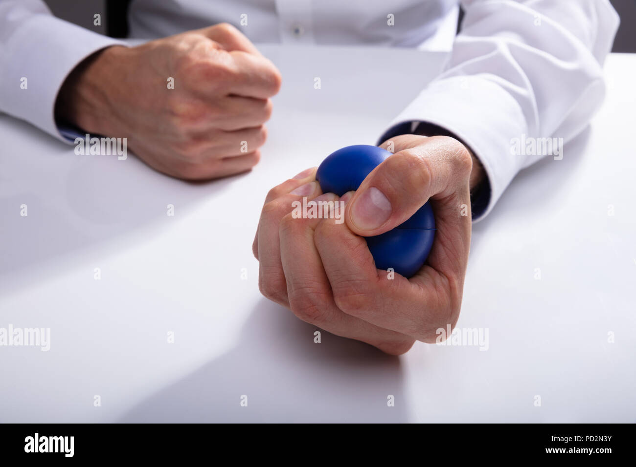 Man pressing stressball hi-res stock photography and images - Alamy