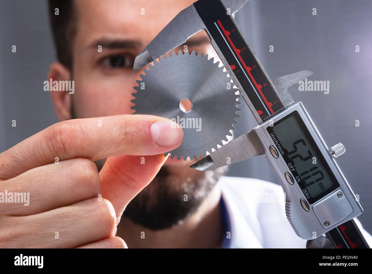 Close-up Of A Man's Hand Measuring Gear's Size With Digital Electronic ...
