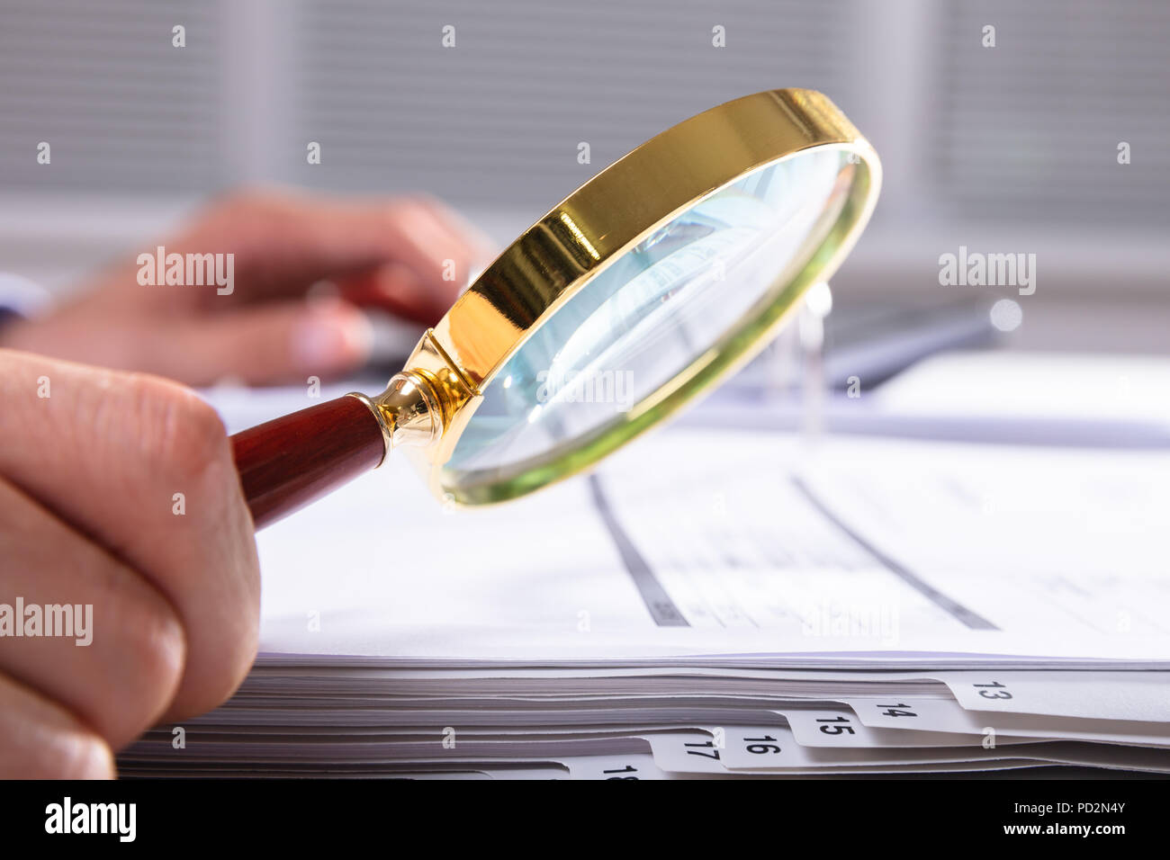 Close-up Of A Businessperson Checking Invoice Through Magnifying Glass ...
