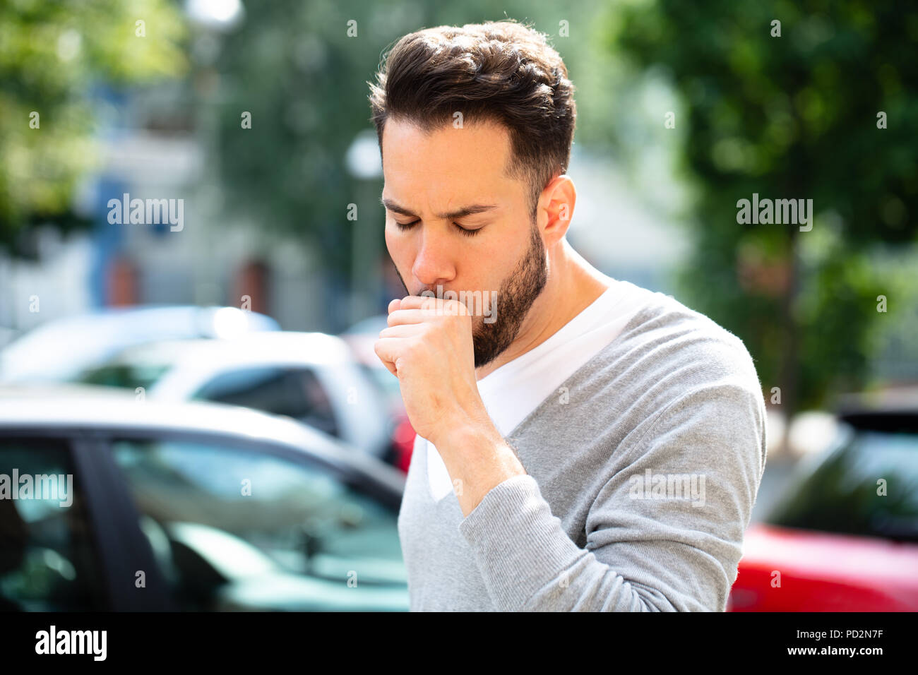 Sick young man coughing standing hi-res stock photography and images - Alamy