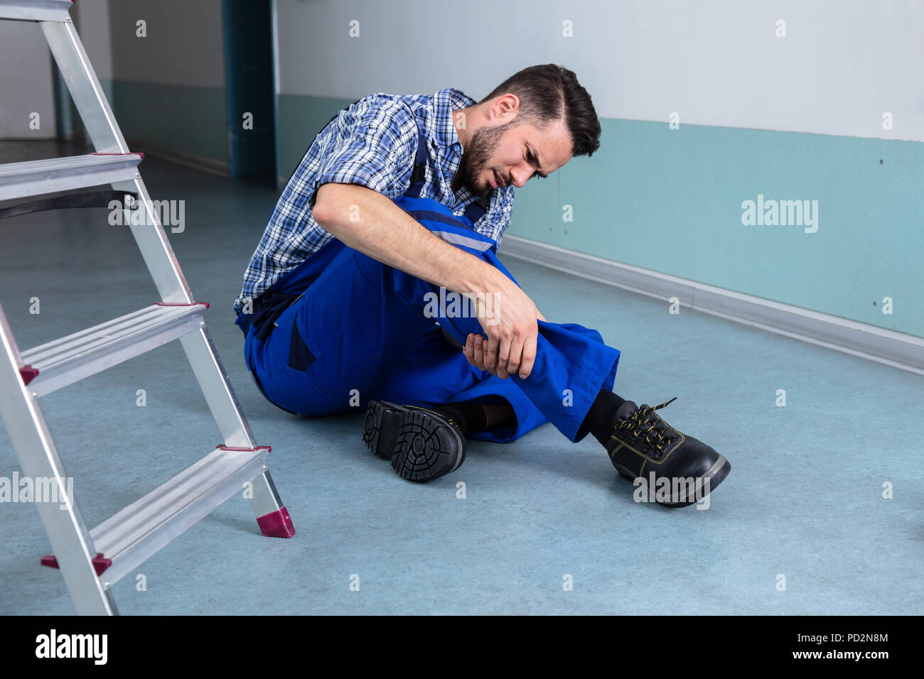 Handyman Touching His Injured Leg After Falling From Ladder Stock Photo ...