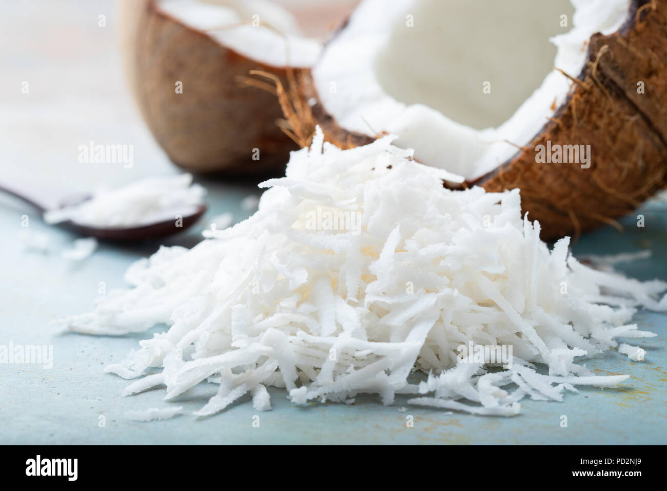 Fresh coconut flakes on a blue background Stock Photo - Alamy