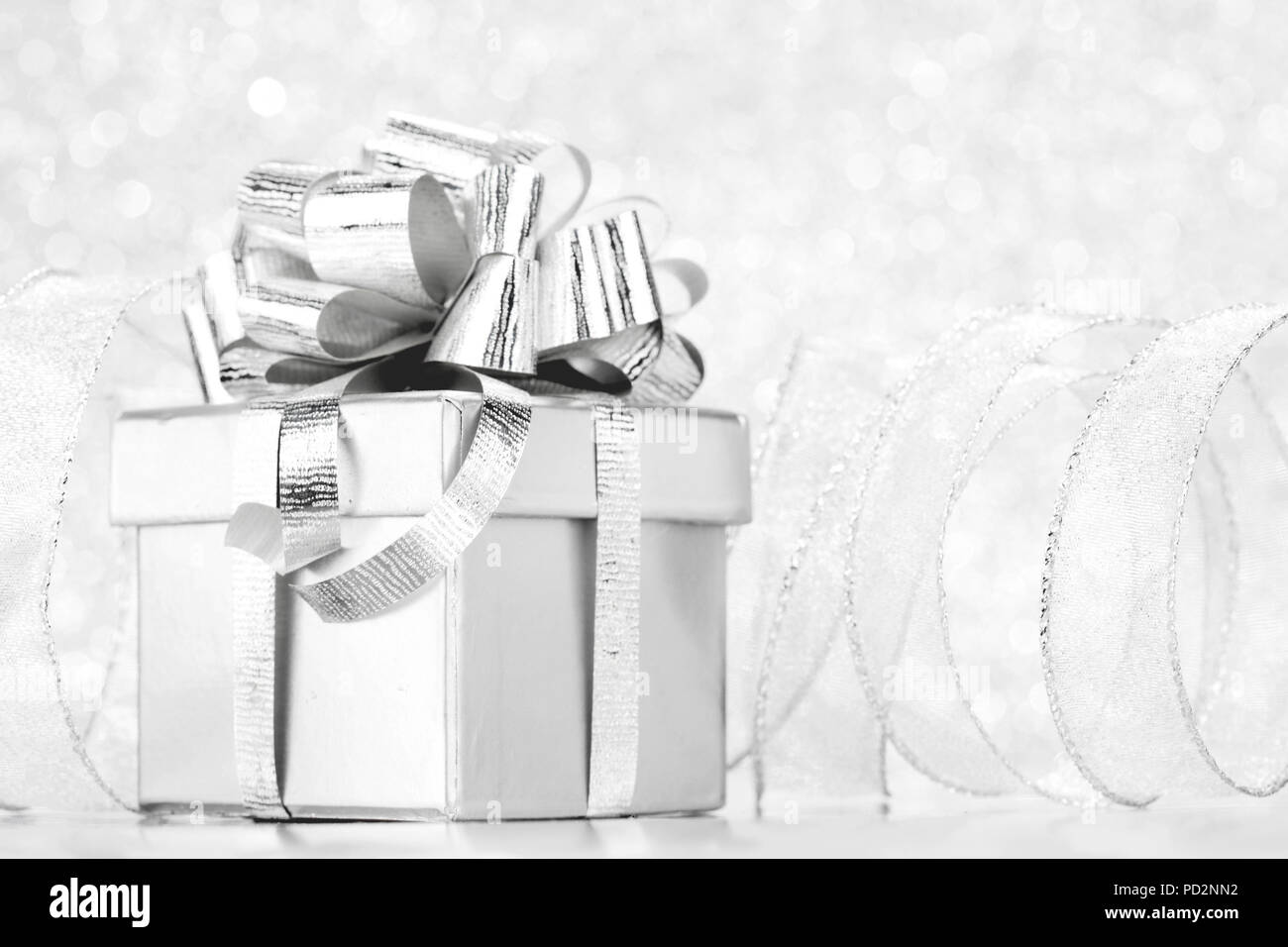 Decorative silver box with holiday gift on shiny glitter background ...