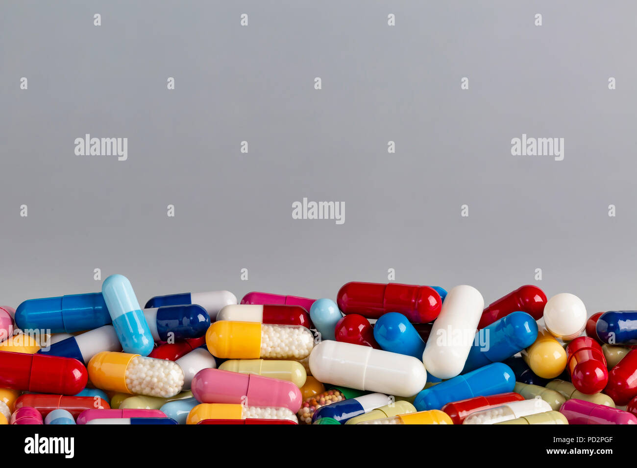 Color capsules and pills on grey background.Medicine horizontal Stock ...