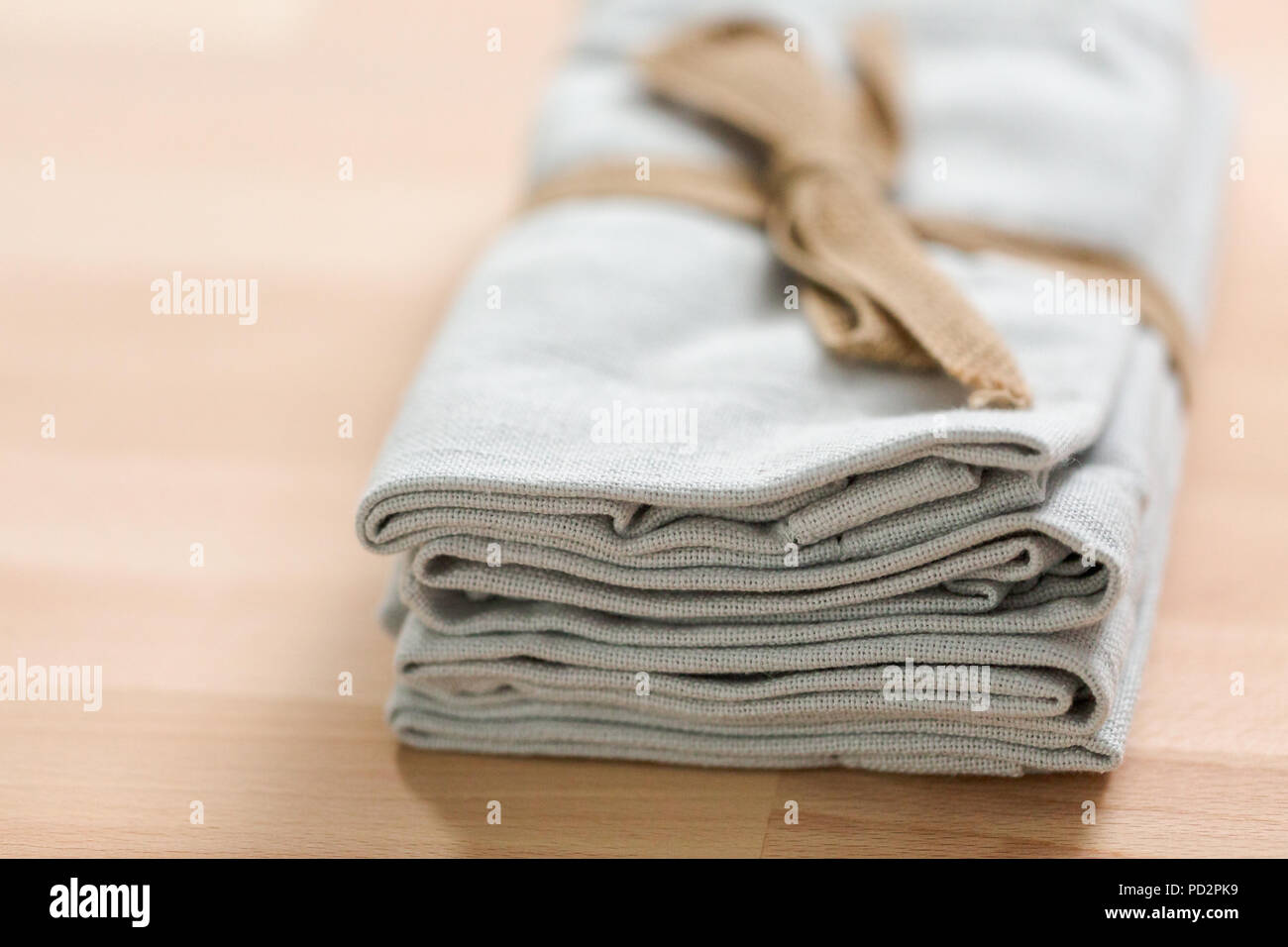Stack of new linen dinner napkin on the kitchen counter Stock Photo - Alamy