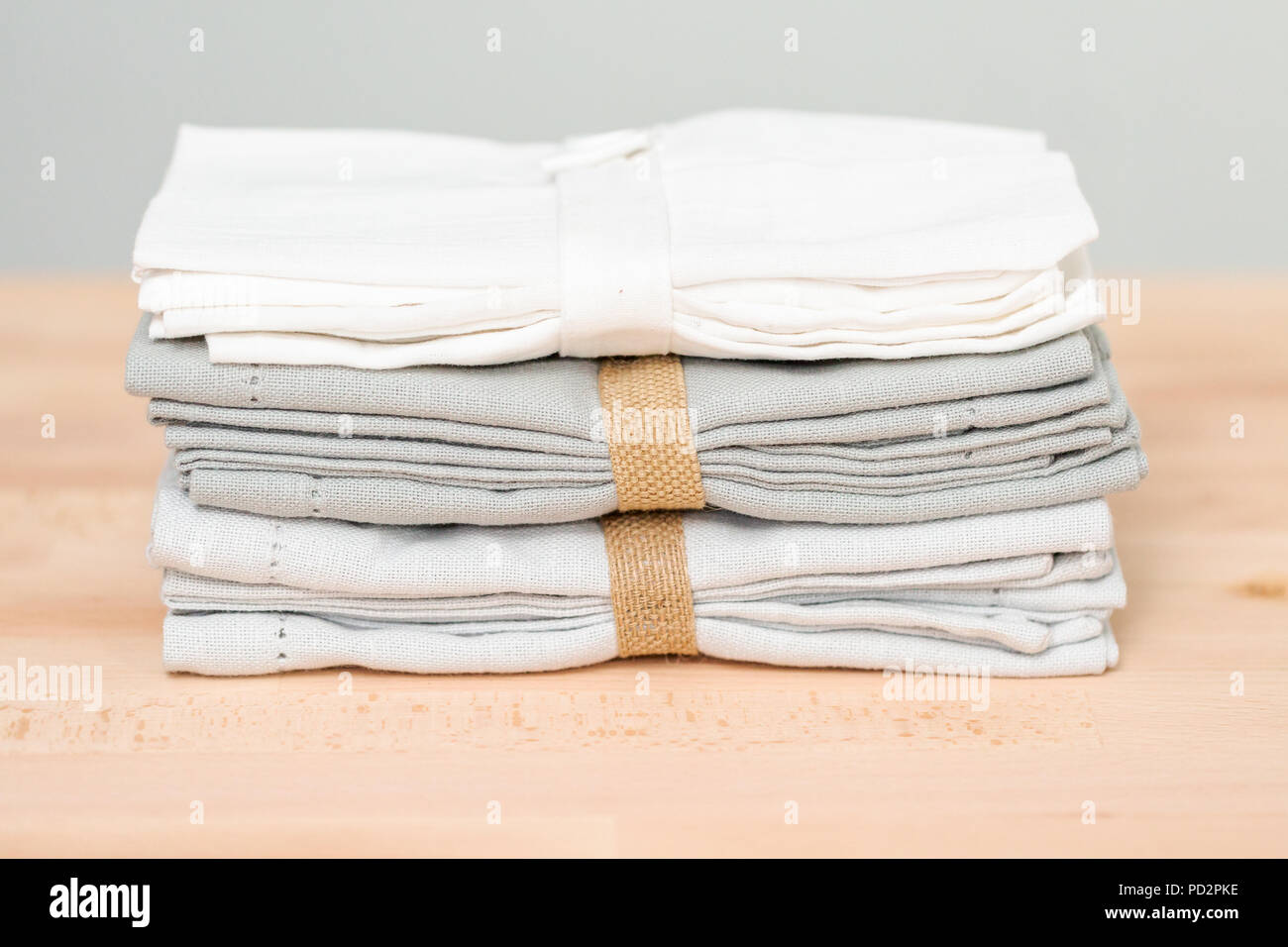 Stack of new linen dinner napkin on the kitchen counter Stock Photo - Alamy