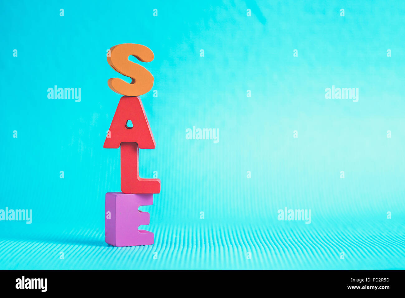 Sale colorful wooden text on blue background with copy space, shopping ...