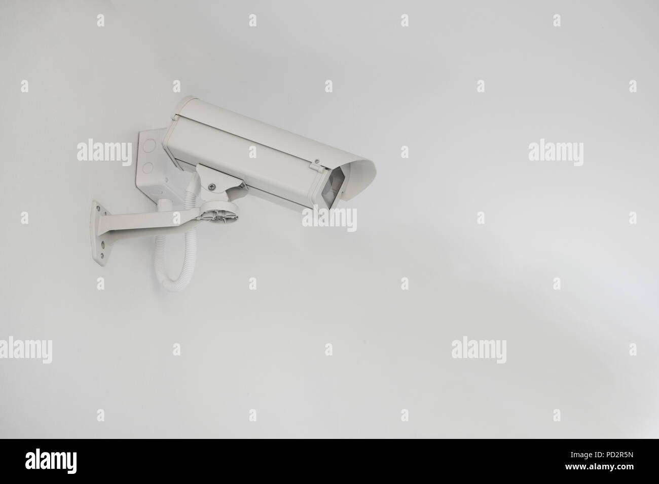 CCTV security camera installed on the building wall, operating indoor ...
