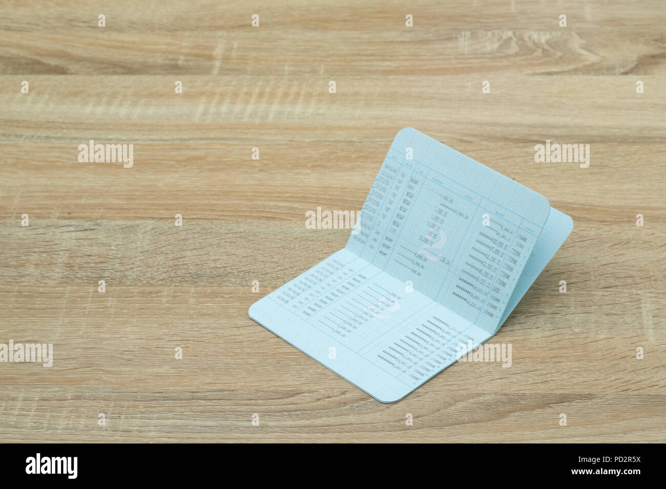 Passbook or account book, statement on wooden working table, savings ...