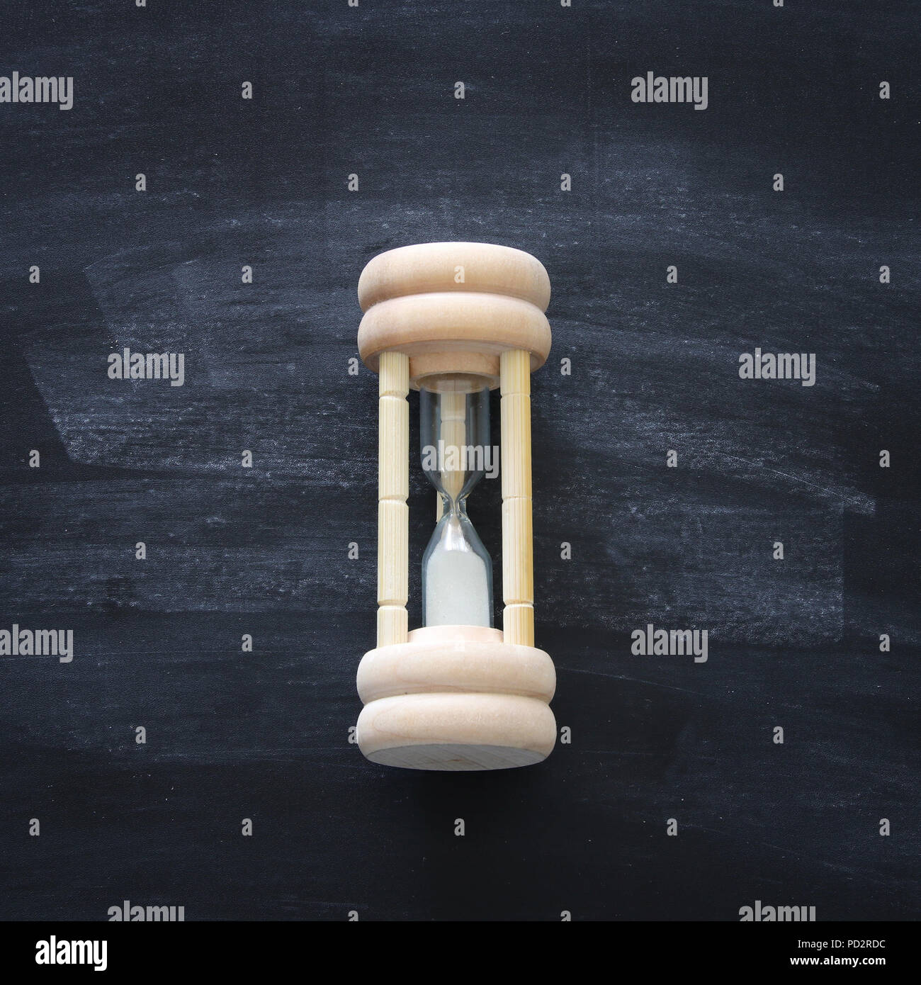 Top view of hourglass over chalkboard background Stock Photo - Alamy
