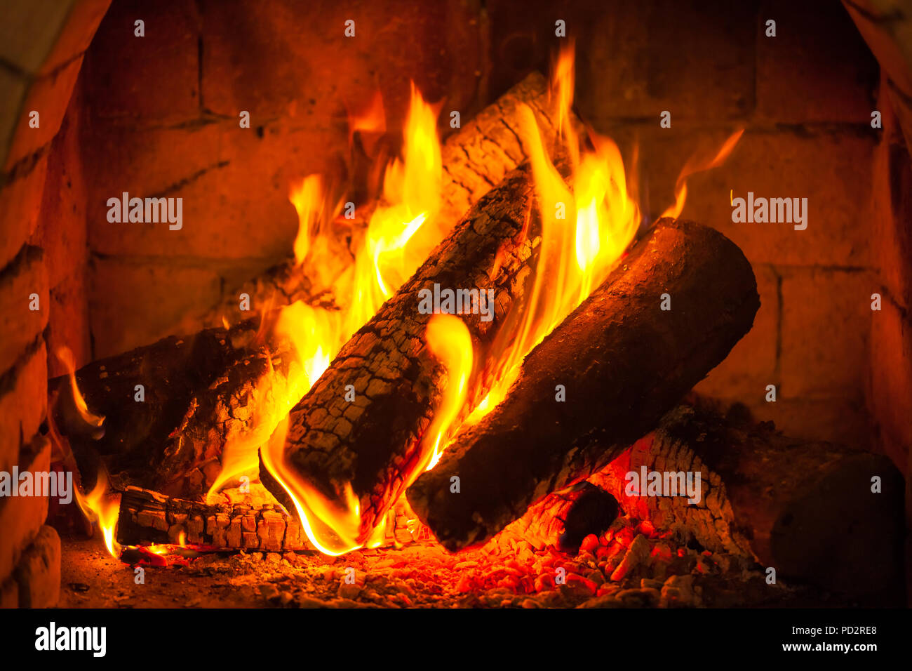 A fire burns in a fireplace, Fire to keep warm Stock Photo - Alamy