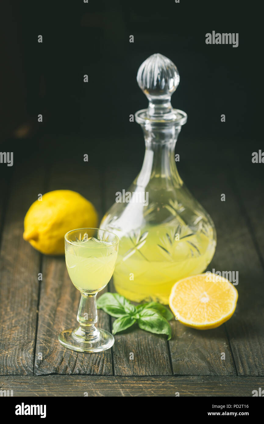 Traditional italian lemon liqueur limoncello and fresh citrus lemon ...