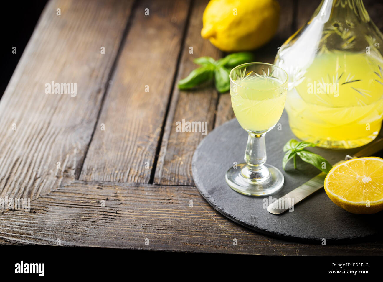 Traditional italian lemon liqueur limoncello and fresh citrus lemon ...