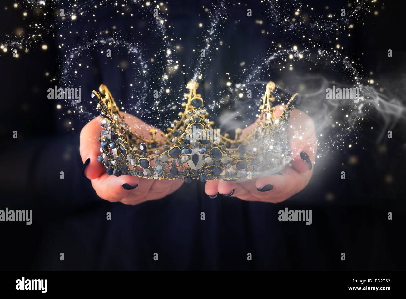 image of lady in black holding queen crown decorated with precious ...