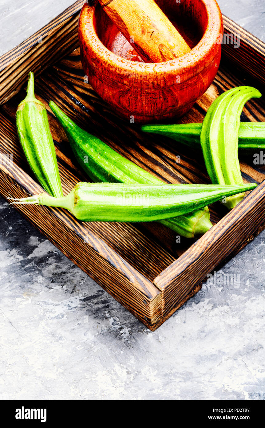Fresh harvest raw green organic okra in a wooden box.Vegetarianism ...