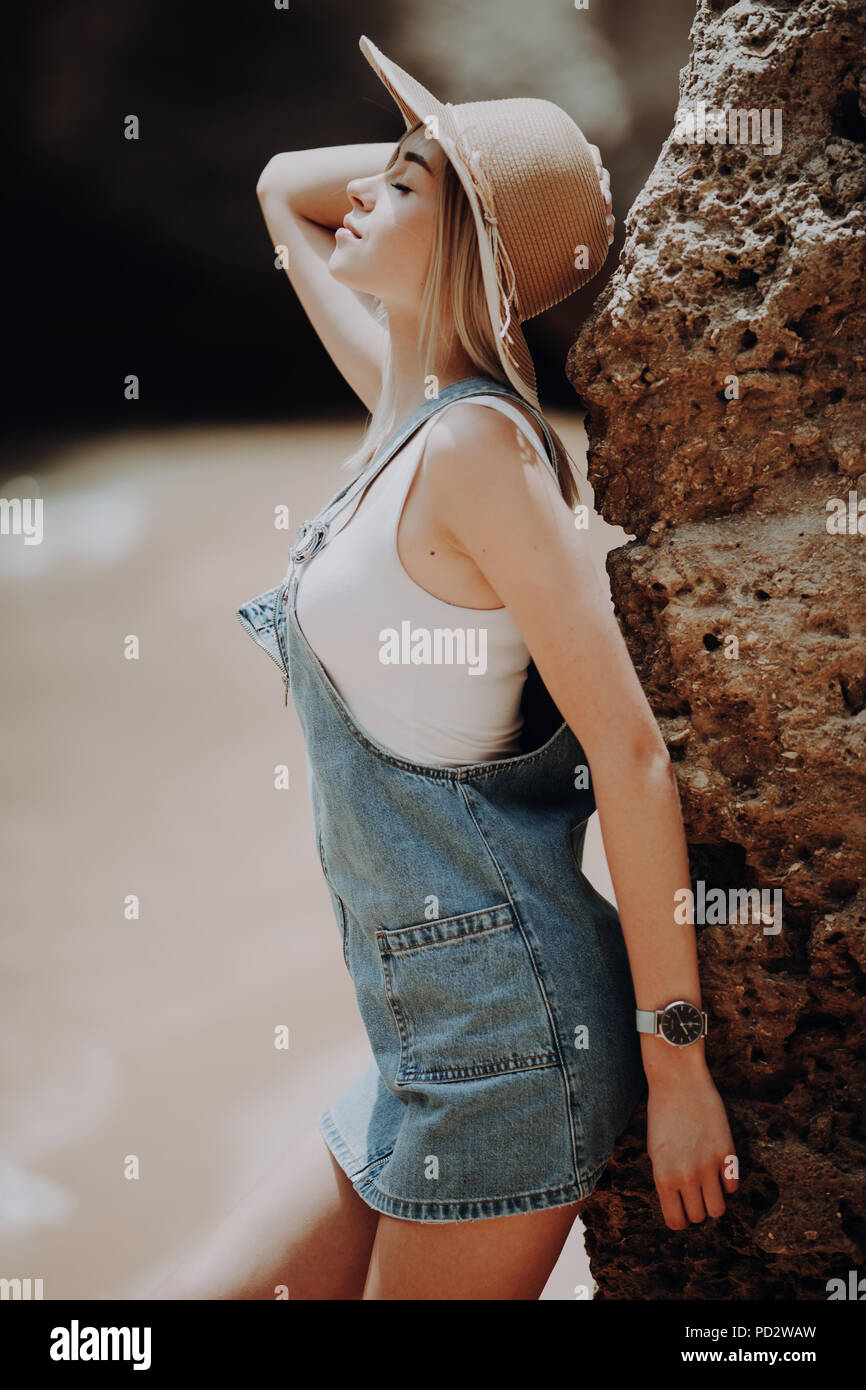 Female leaning against rock hi-res stock photography and images - Alamy