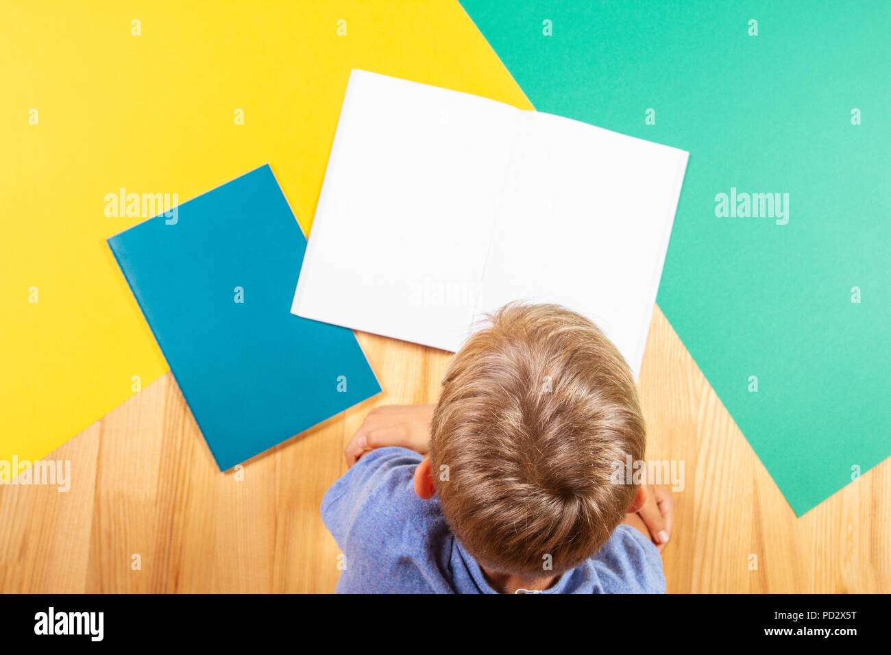 Kid with colorful books notebooks reading and doing homework Stock ...