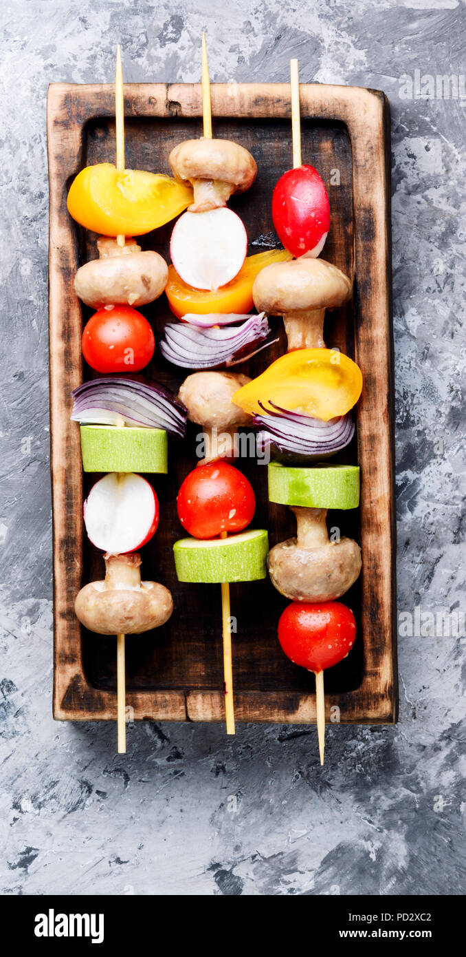 Grilled vegetable kebabs on skewers with tomato, pepper, mushrooms ...