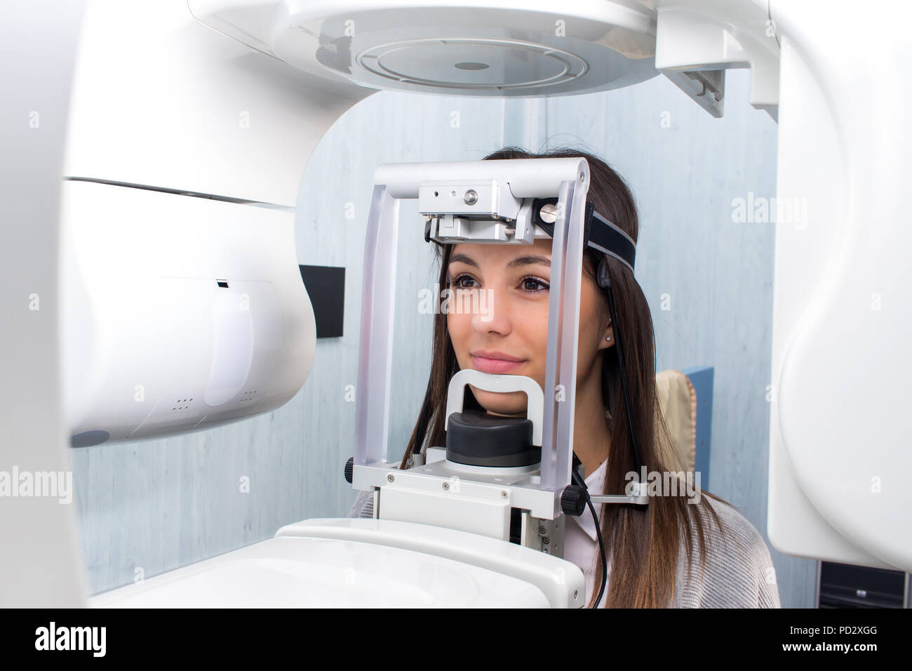 Close up head shot of girl taking dental tac with cephalometric ...