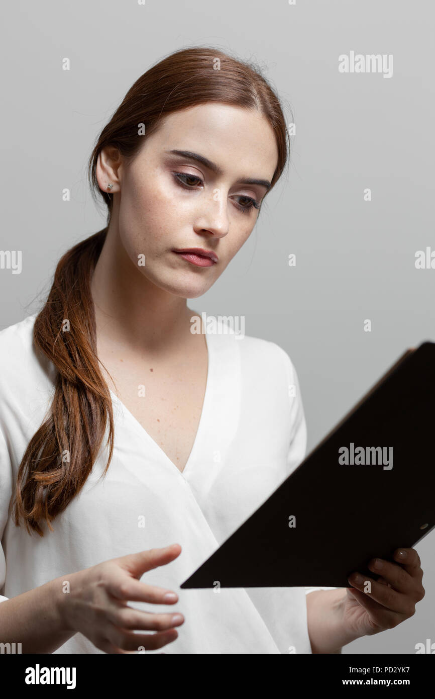 Woman reading documents Stock Photo - Alamy