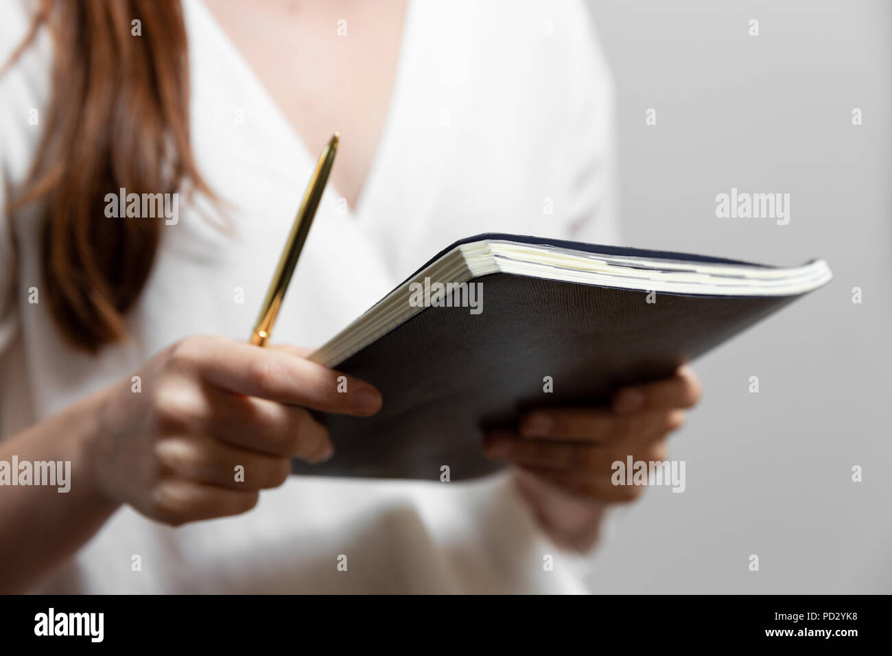 Woman with notepad and pencil Stock Photo - Alamy