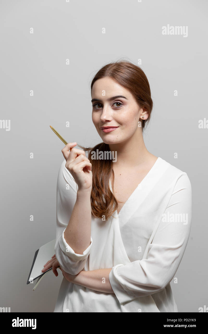 Woman with notepad and pencil Stock Photo - Alamy