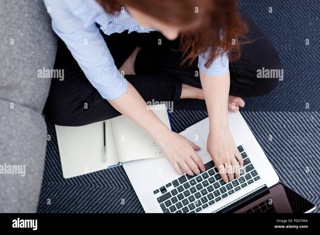 Woman sitting on floor using laptop Stock Photo - Alamy
