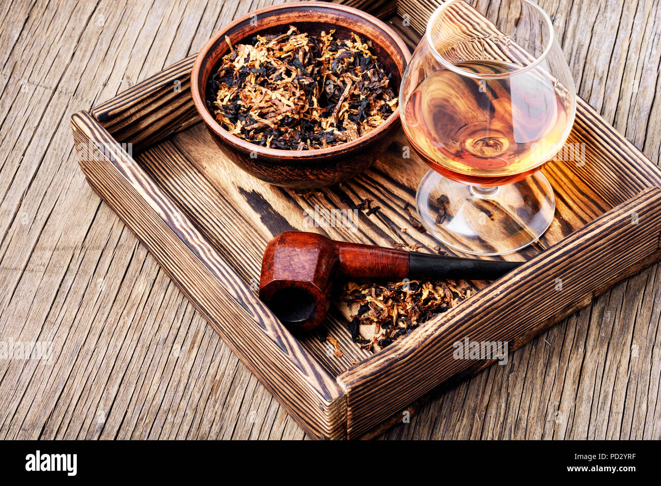 Glass of cognac and pipe with tobacco Stock Photo - Alamy