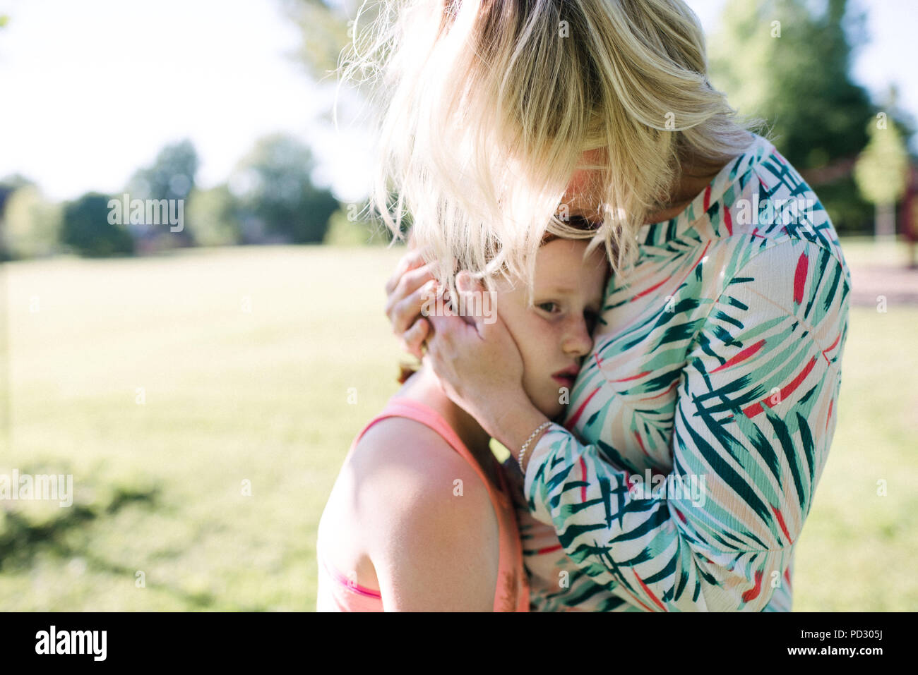 Mother consoling daughter in park Stock Photo - Alamy
