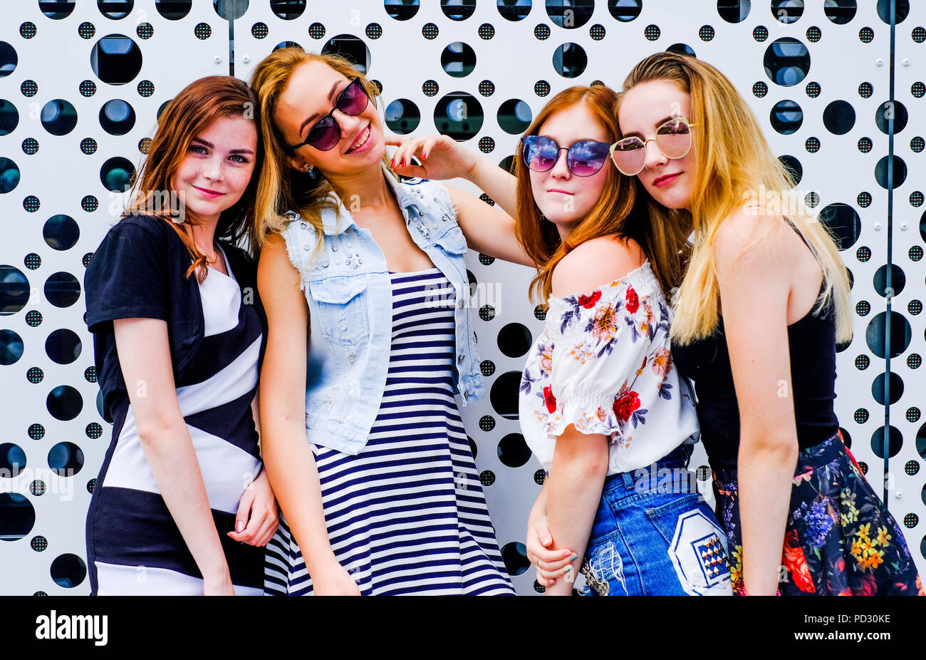 Friends posing against screen Stock Photo - Alamy