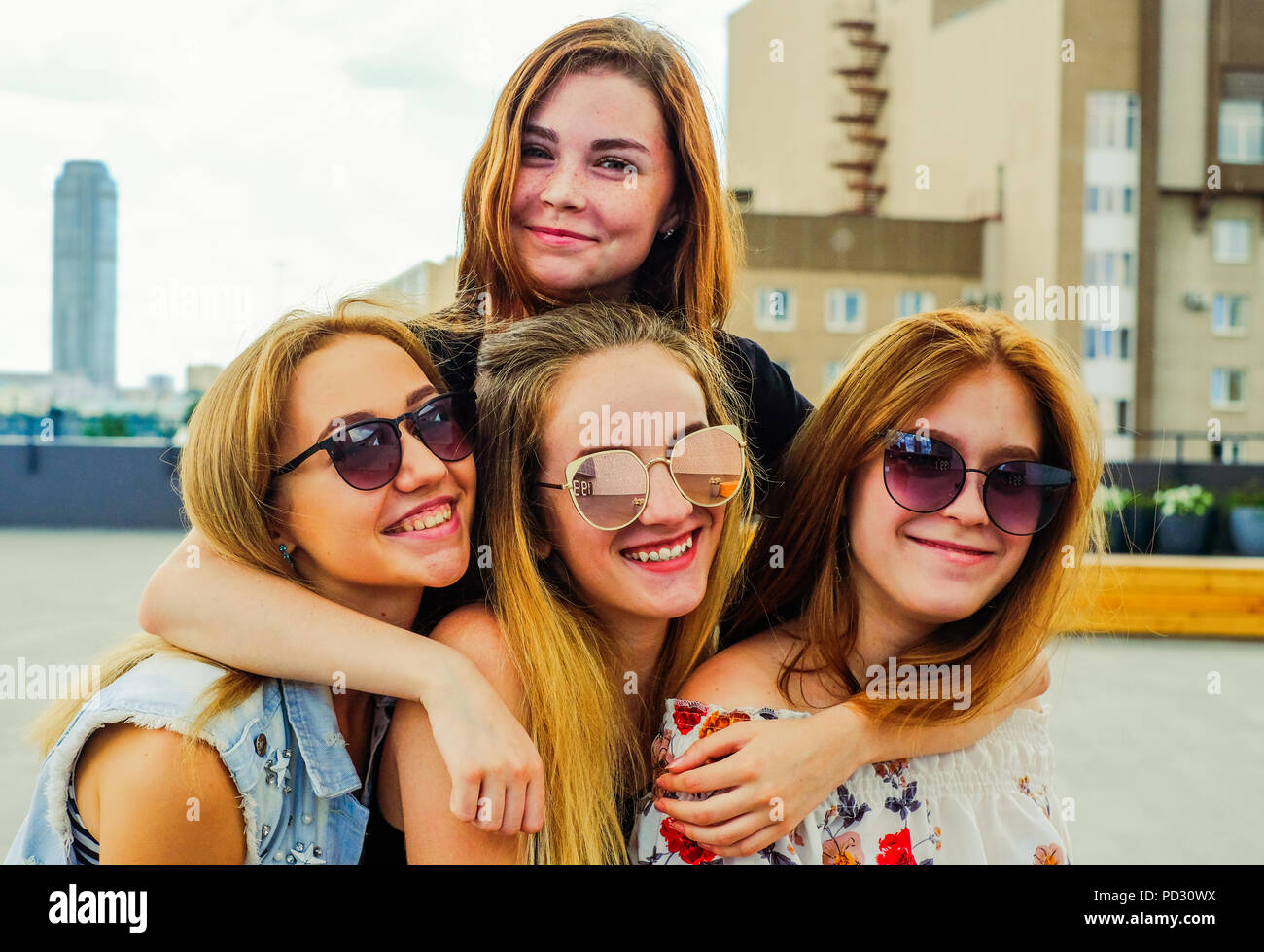 Four friends hugging hi-res stock photography and images - Alamy