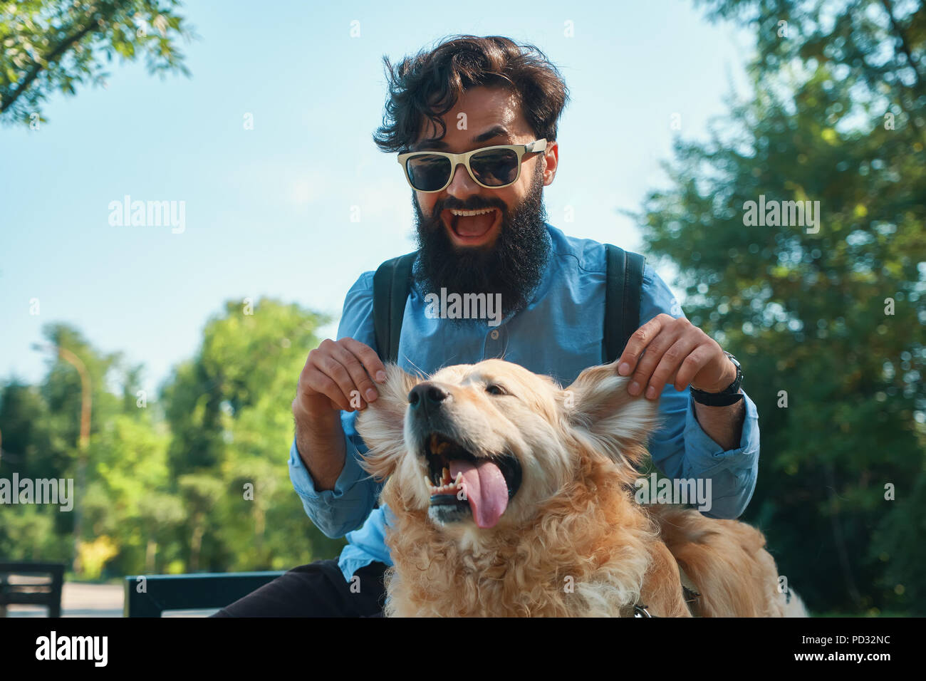 Man and dog having fun, playing, making funny faces while restin Stock ...