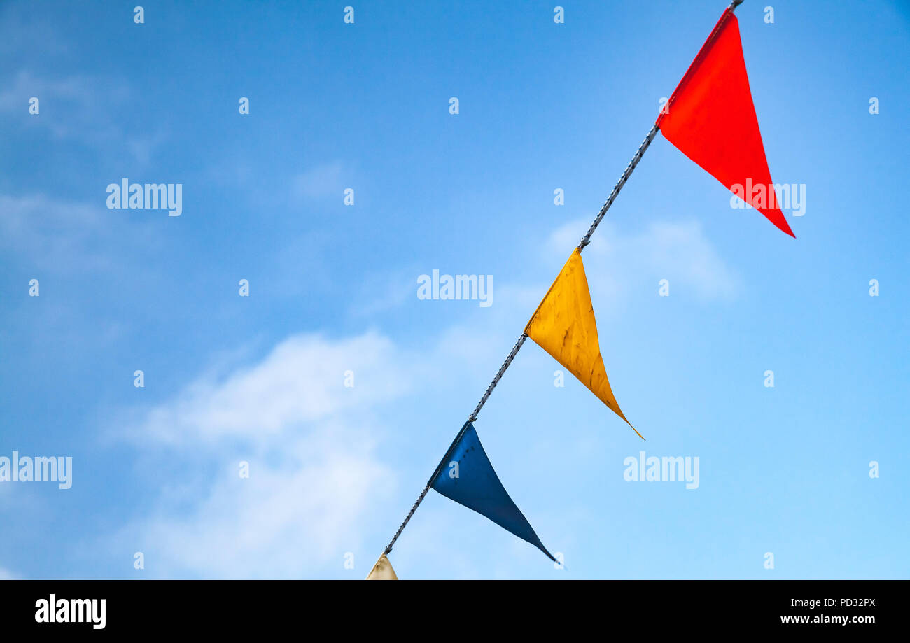 Colorful triangle flags banner on blue cloudy sky background Stock ...
