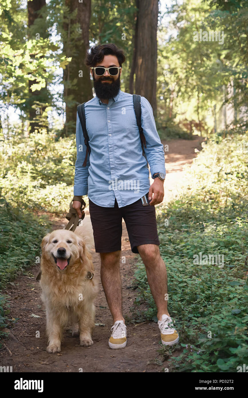 Handsome man walking his dog in outdoors Stock Photo - Alamy