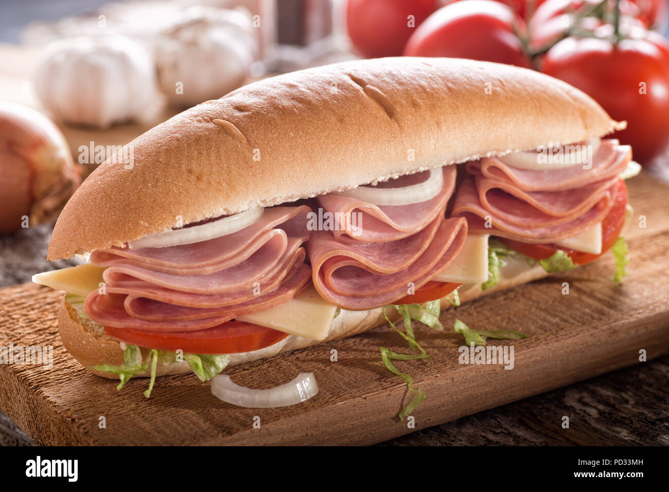 A delicious submarine sandwich with deli meats, lettuce, tomato, onion ...