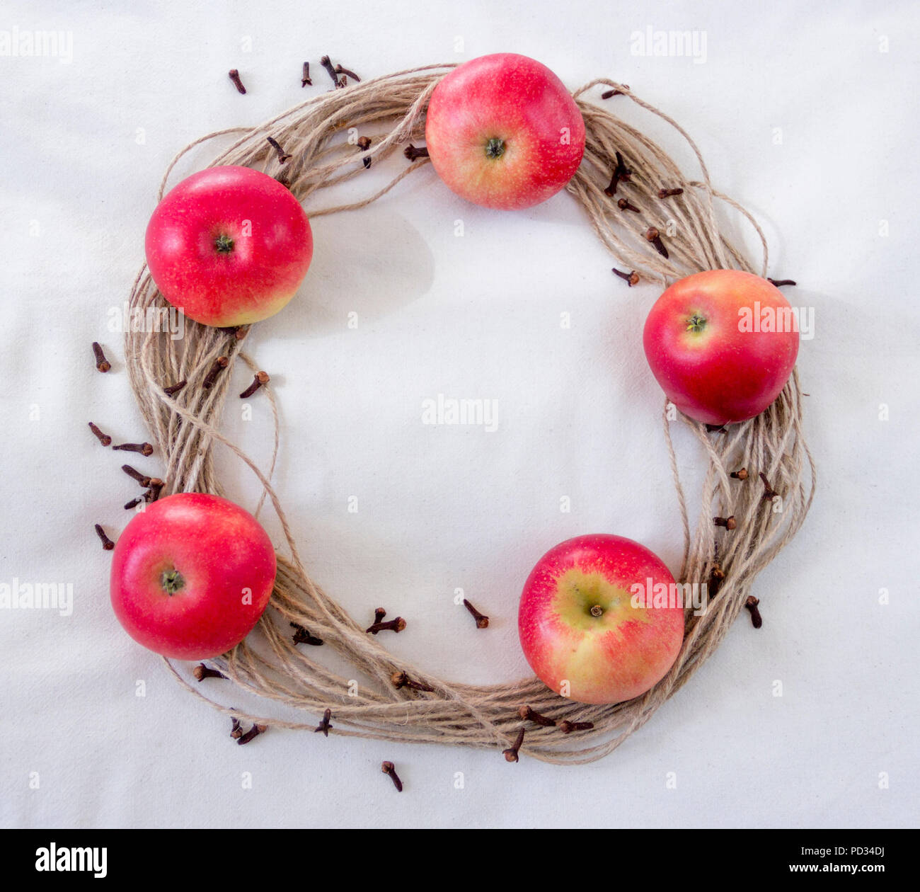 Hessian, twine, jute string wreath with red apples and brown cloves on ...