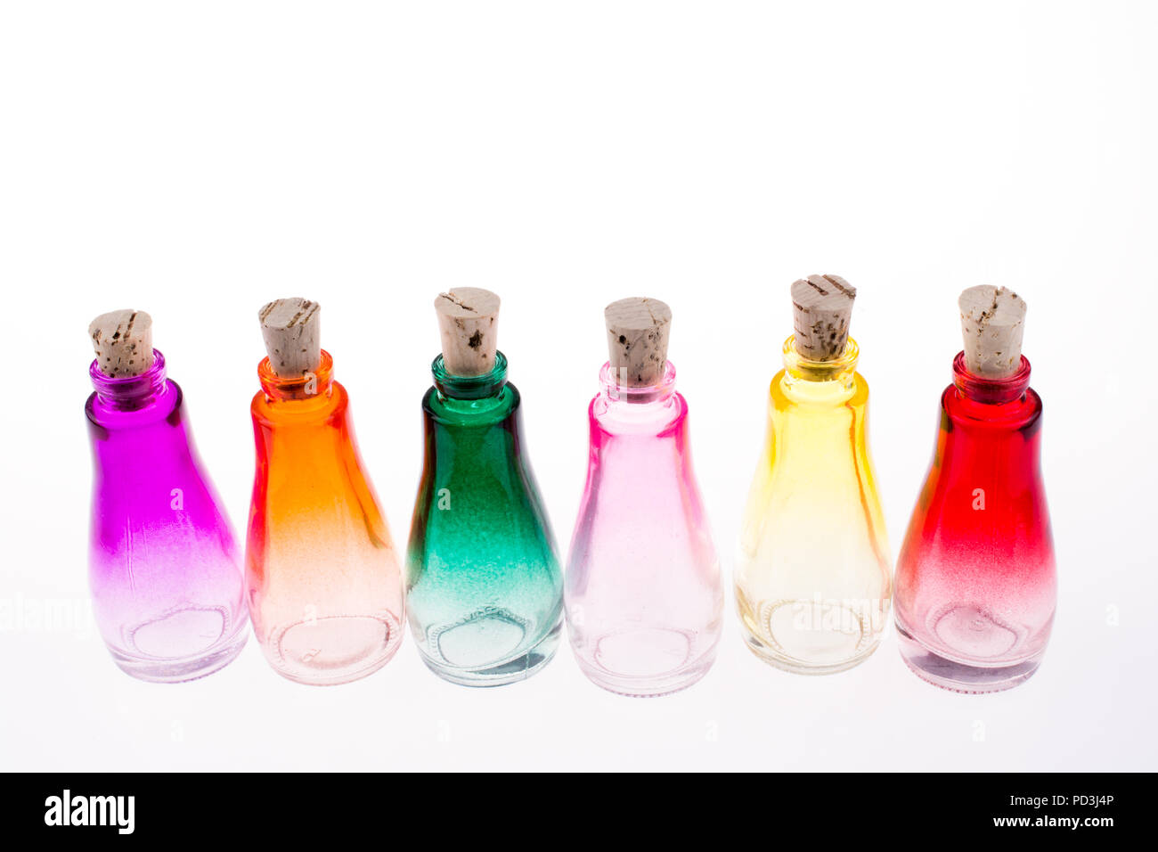 colored empty bottles on a white background Stock Photo - Alamy