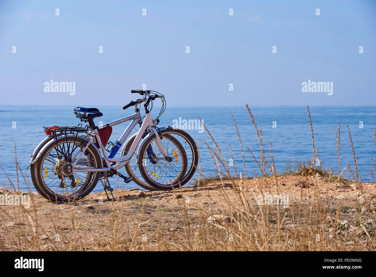 Two bicycles on the beach on background a blue sea on a sunny day Stock ...