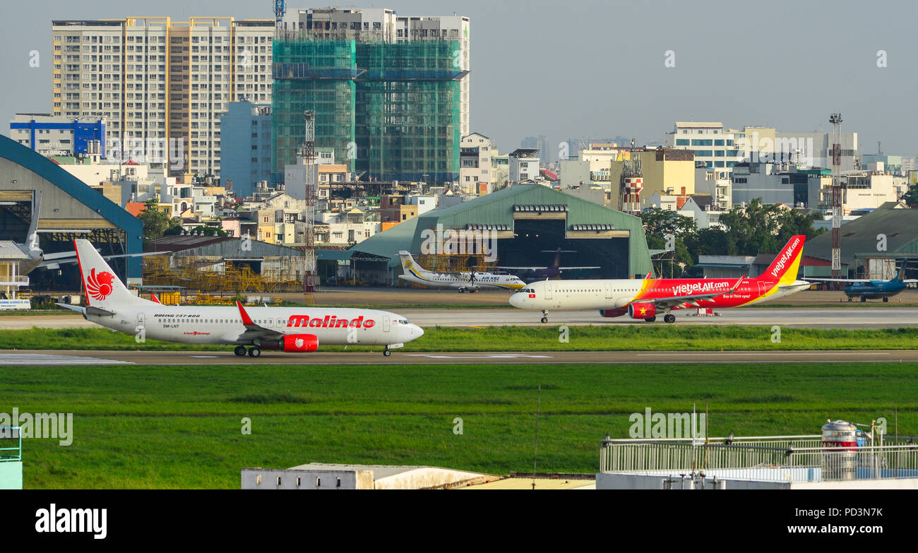 Saigon, Vietnam - Jun 26, 2018. Passenger airplanes taxiing on runway ...