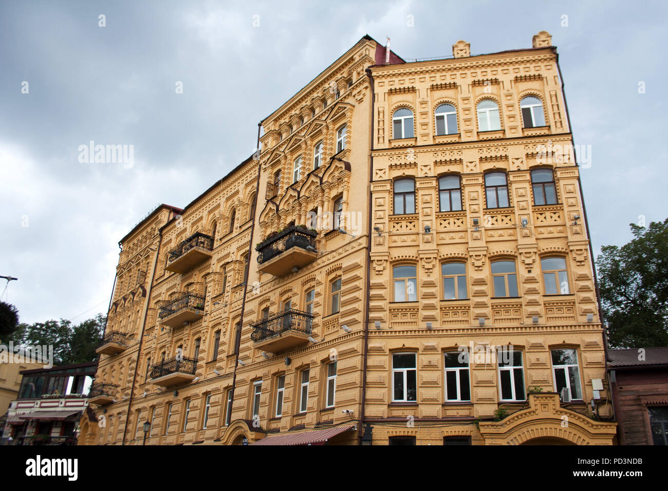Yellow residential building facade with old urban architecture in ...