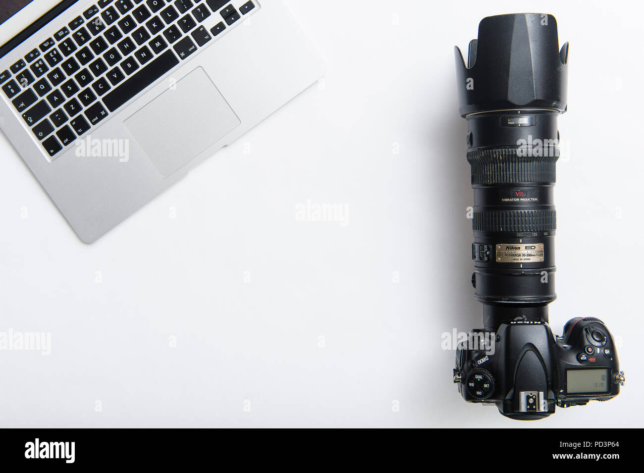 Top down view of camera equipment on white tabletop, DSLR with ...