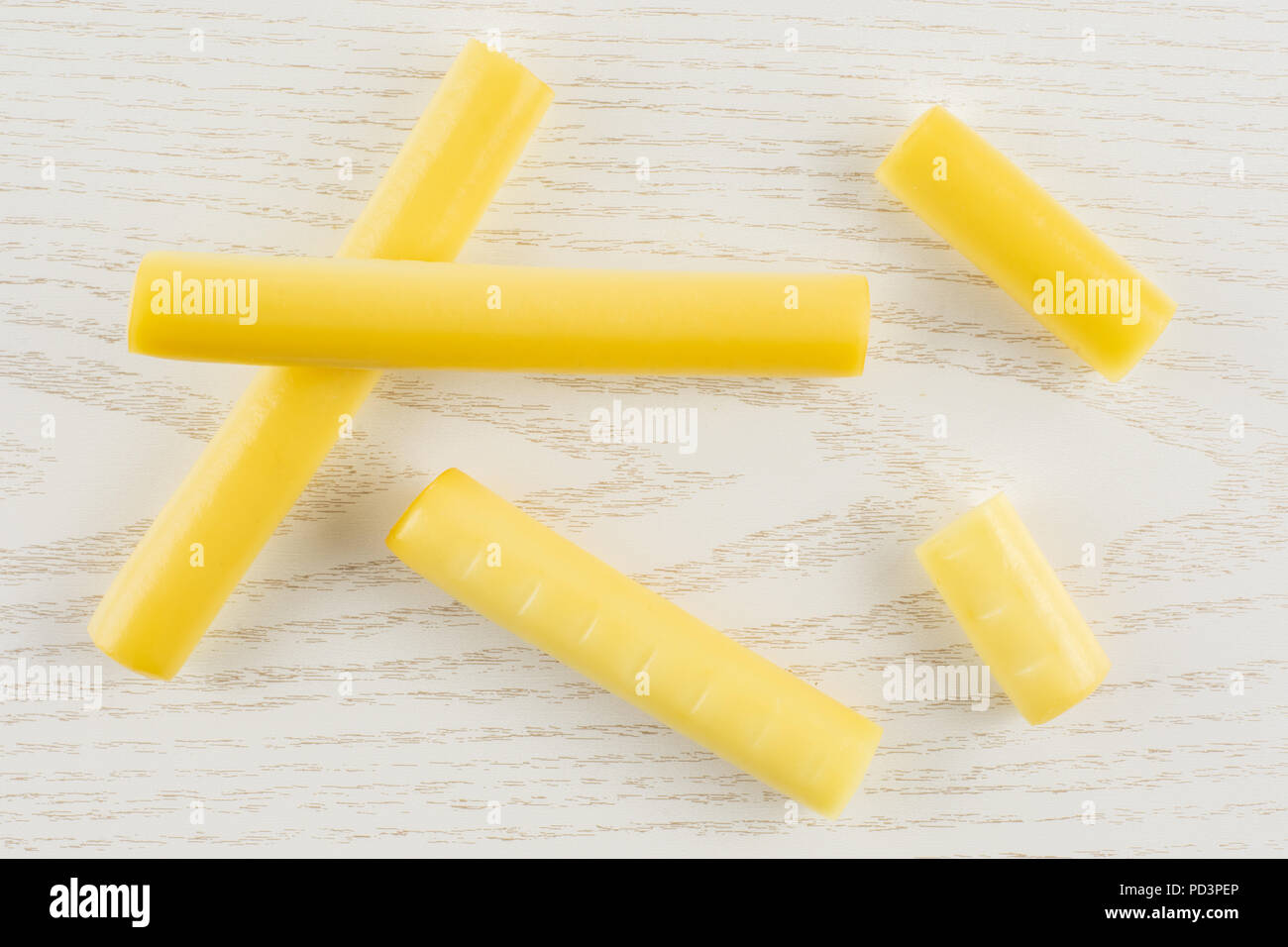 Group of five whole smoked slovak string cheese stick flatlay on grey ...