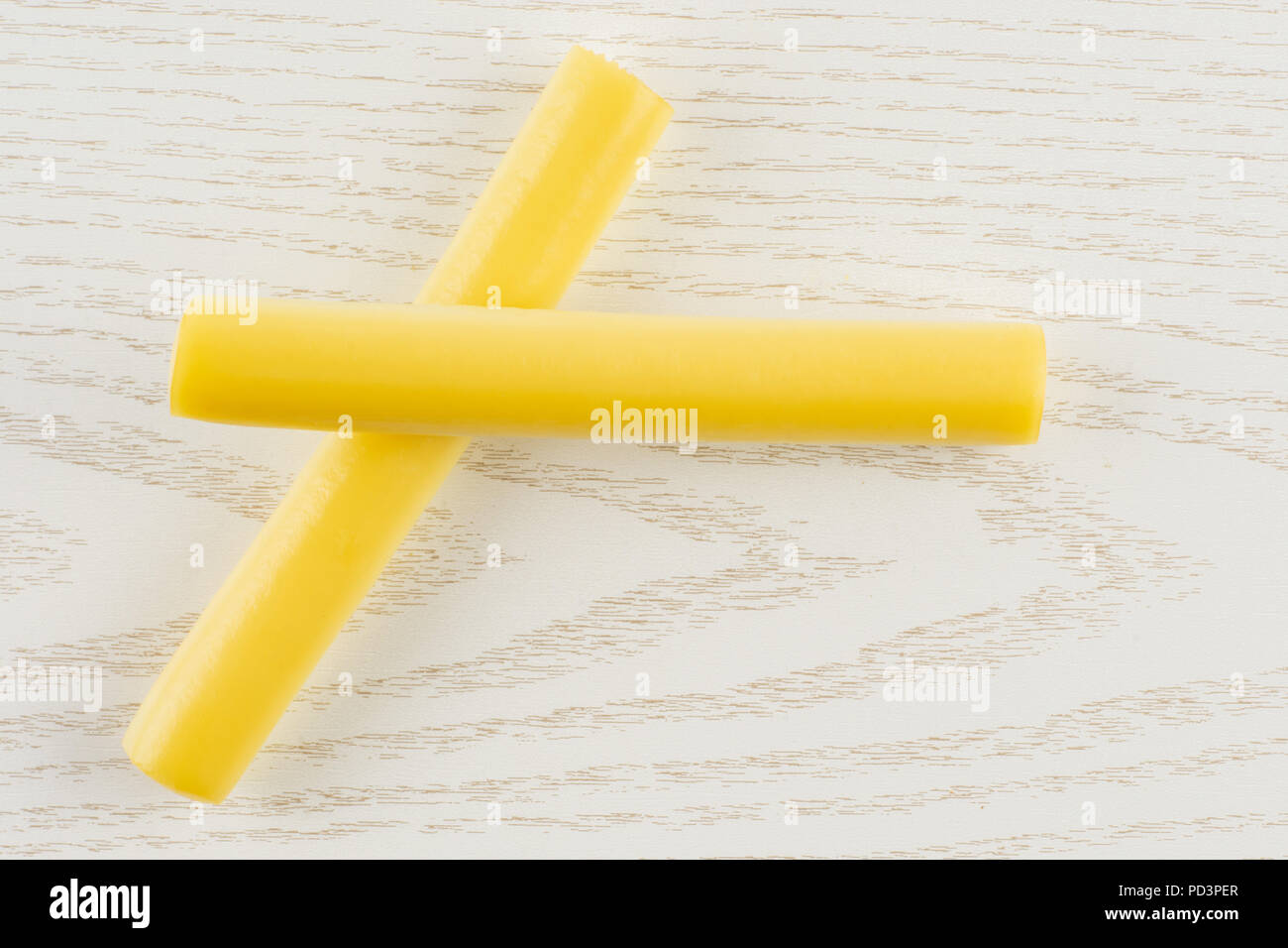 Group of two whole smoked slovak string cheese stick flatlay on grey ...