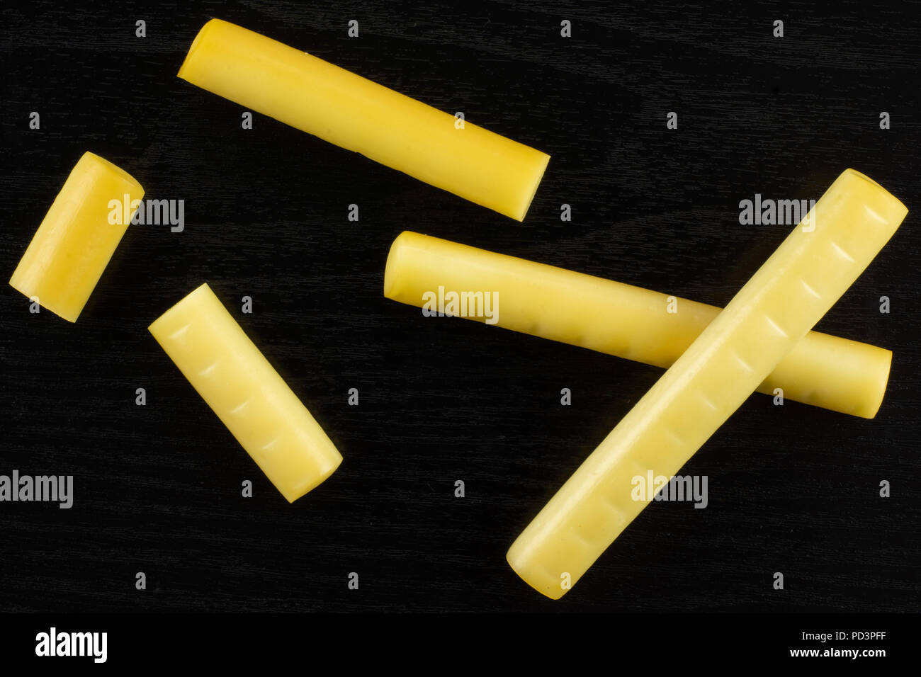 Group of five whole smoked slovak string cheese stick flatlay on black ...