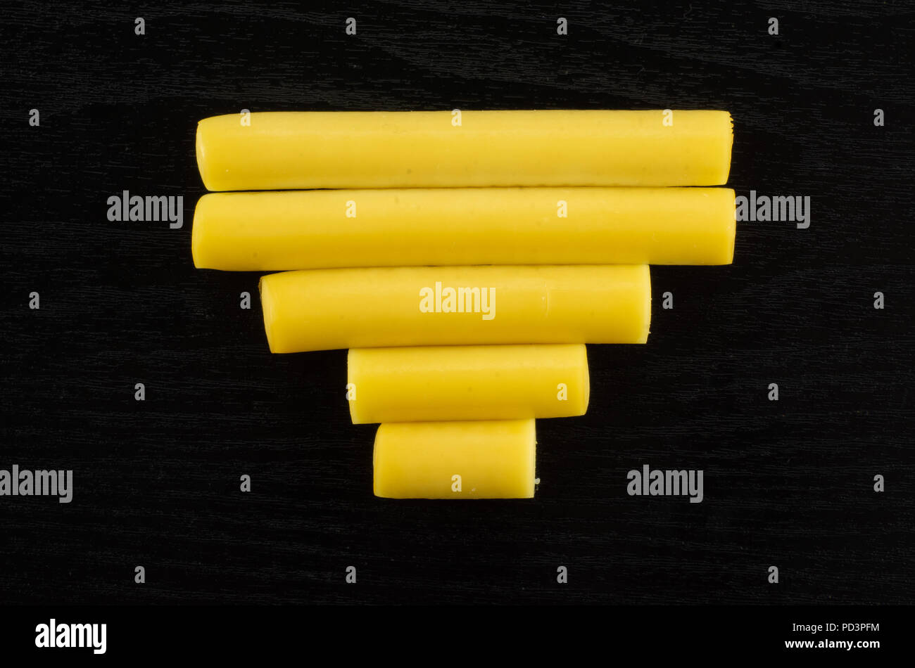 Group of five whole smoked slovak string cheese stick in line flatlay ...