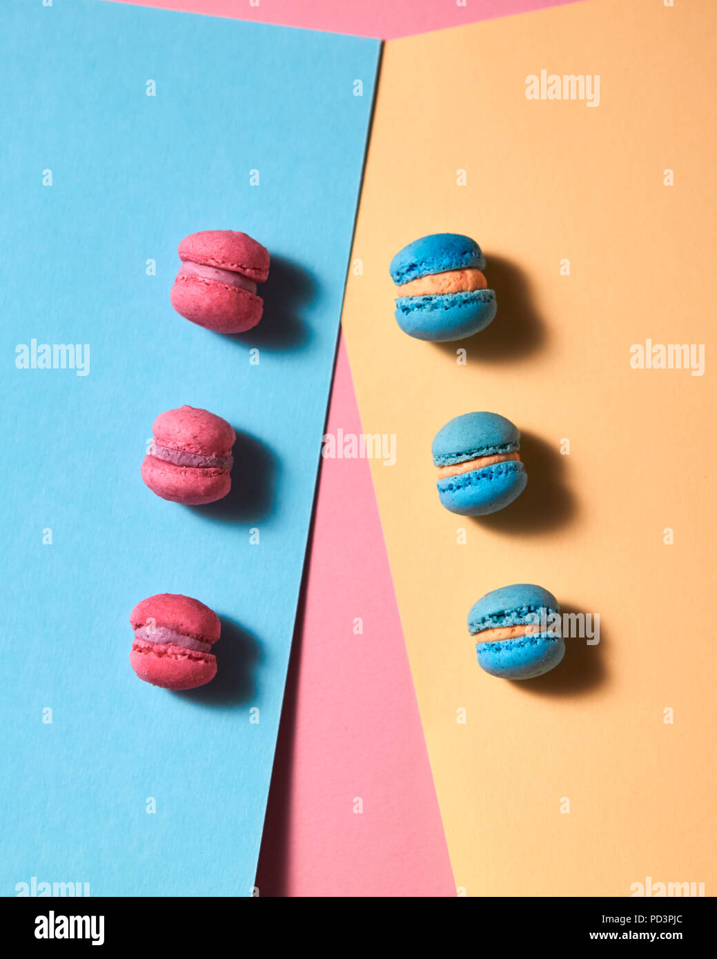 Pattern from different macaroons on a multicolored paper background ...