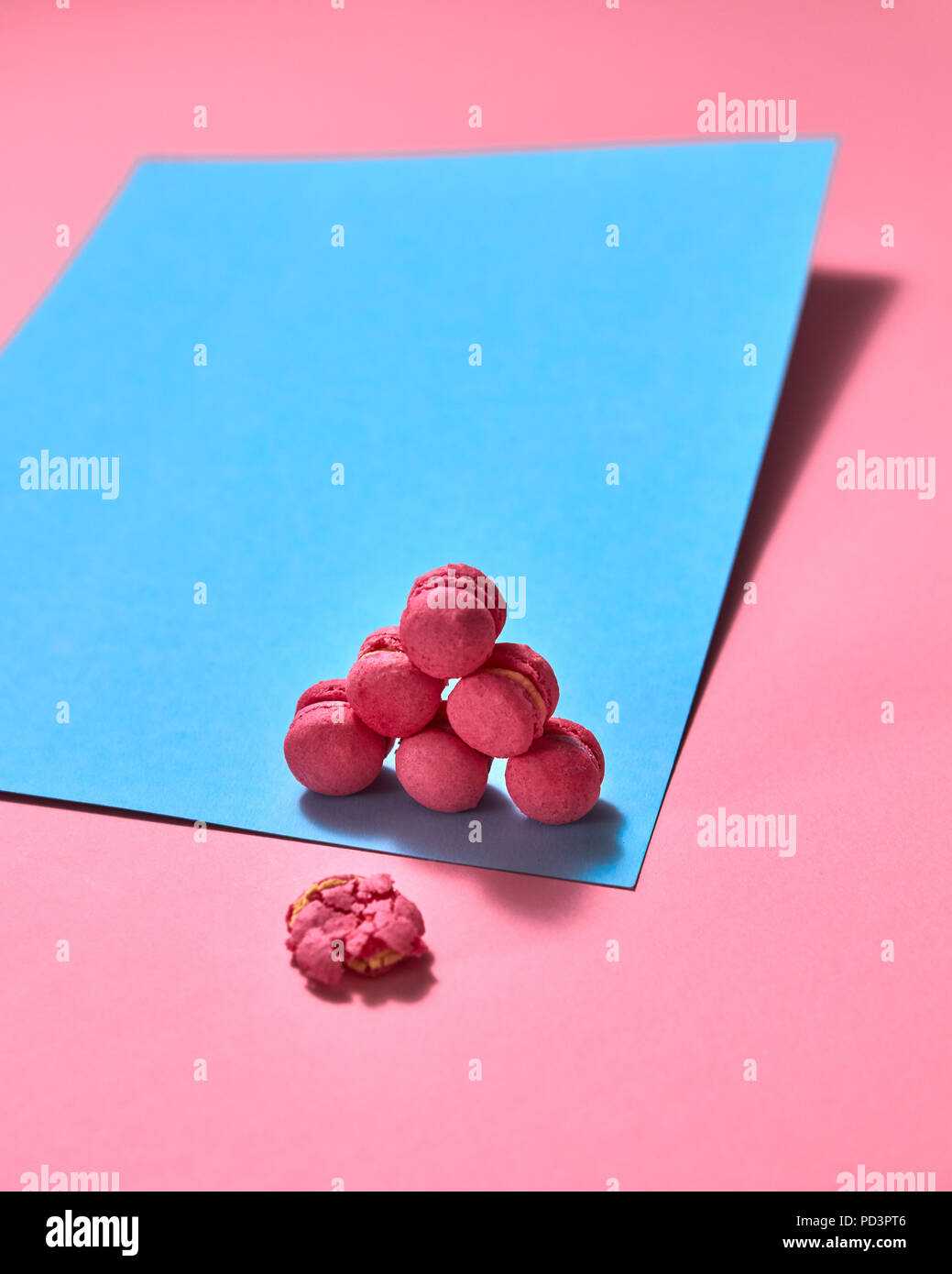 Pink bright macaroons are presented in the form of a triangular pyramid ...